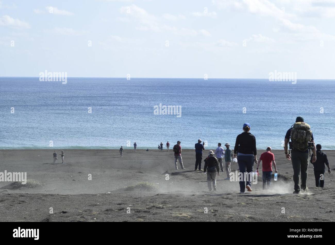 U.S. Air Force Airmen from Kadena Air Base, Japan, walk down a beach ...