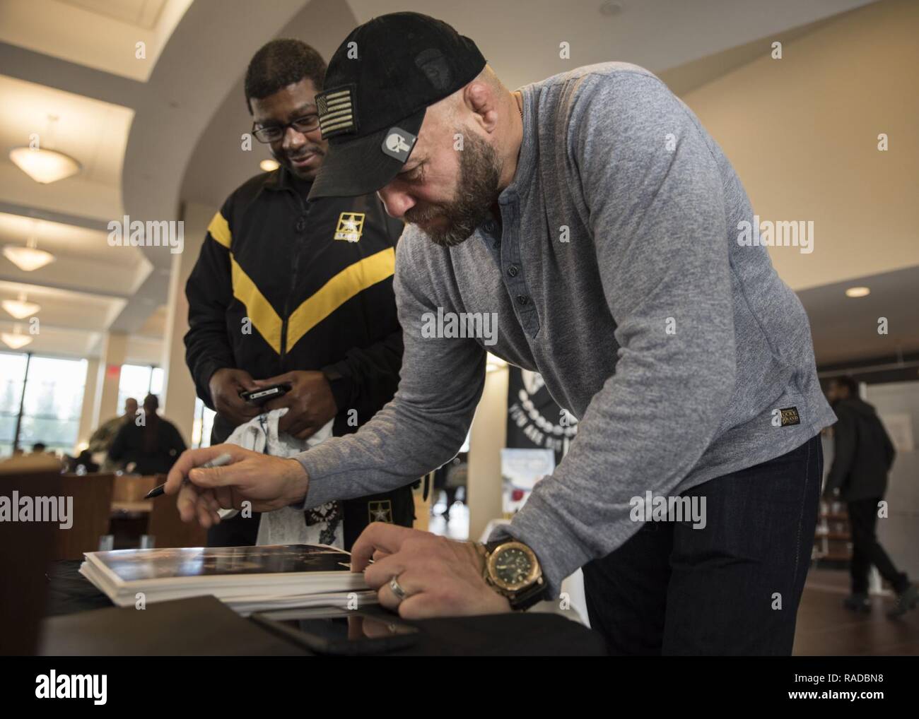Retired mixed martial arts fighter Randy Couture signs a photo for a ...