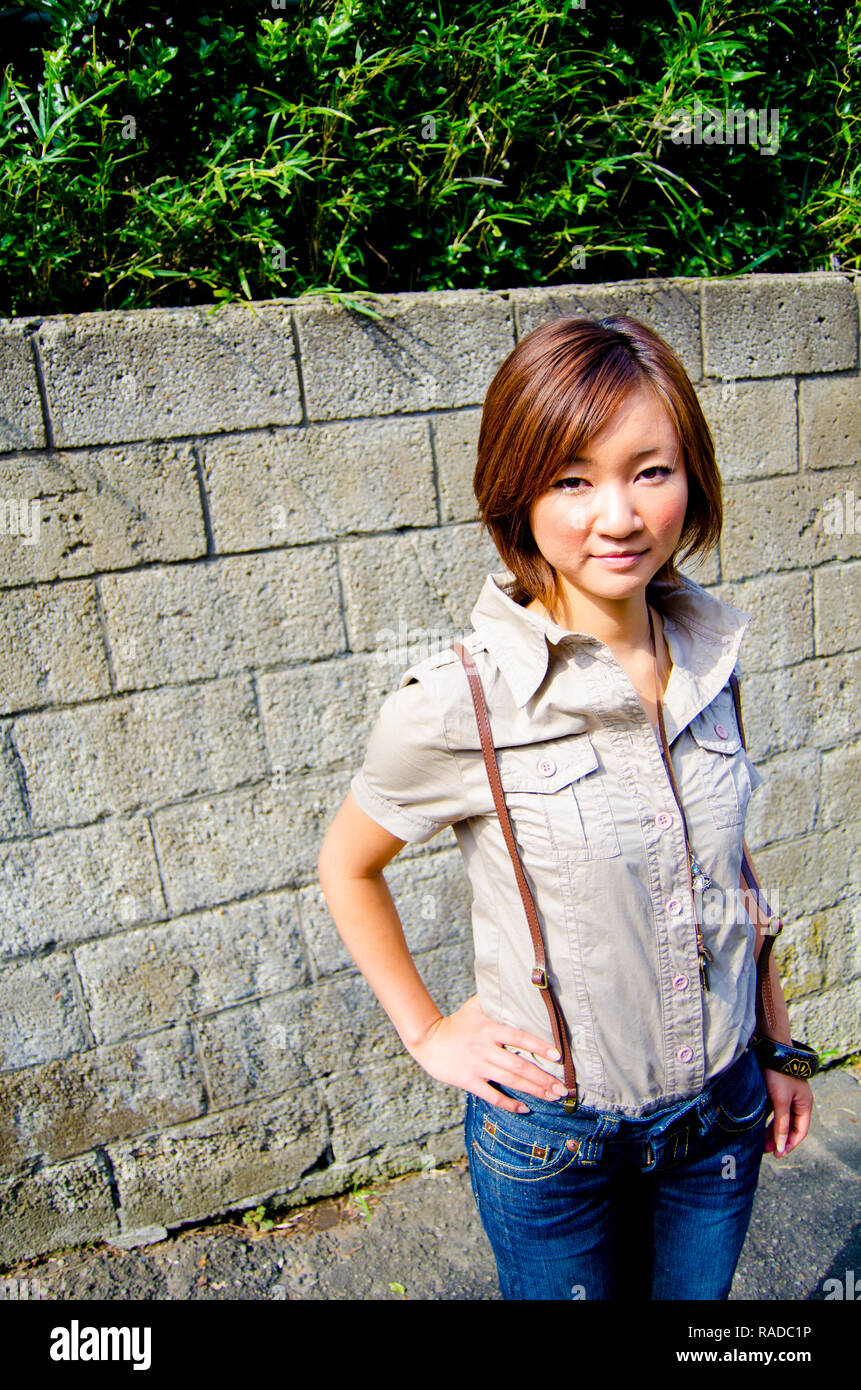 Asian female model poses for pictures on the street Stock Photo - Alamy
