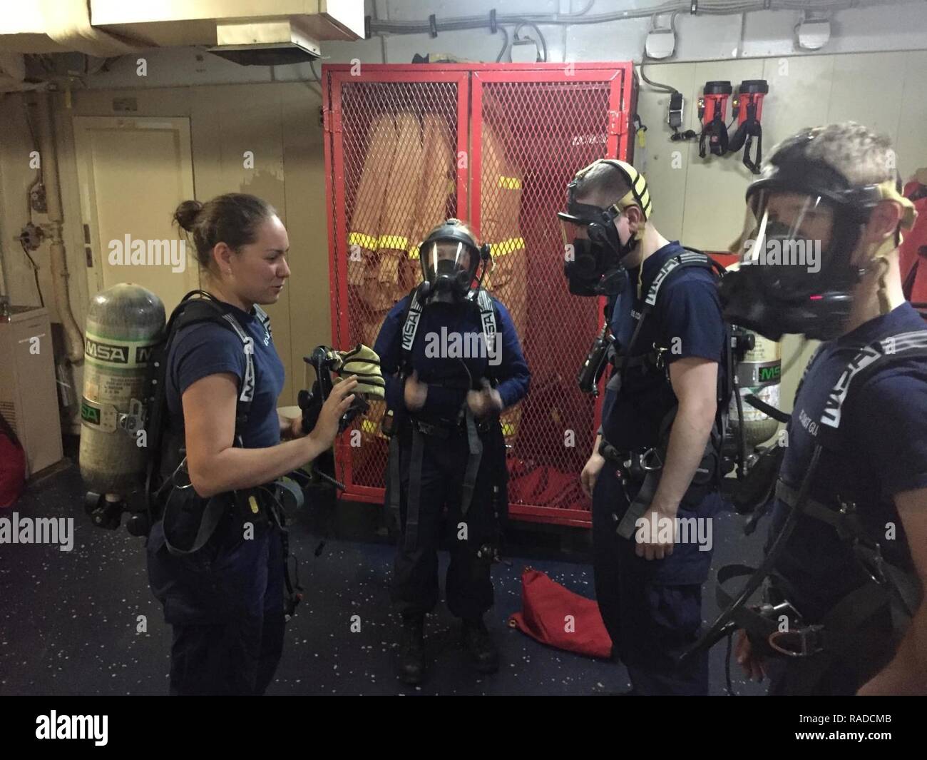U.S. Coast Guard Petty Officer 3rd Class Courtney Will (left), a damage ...