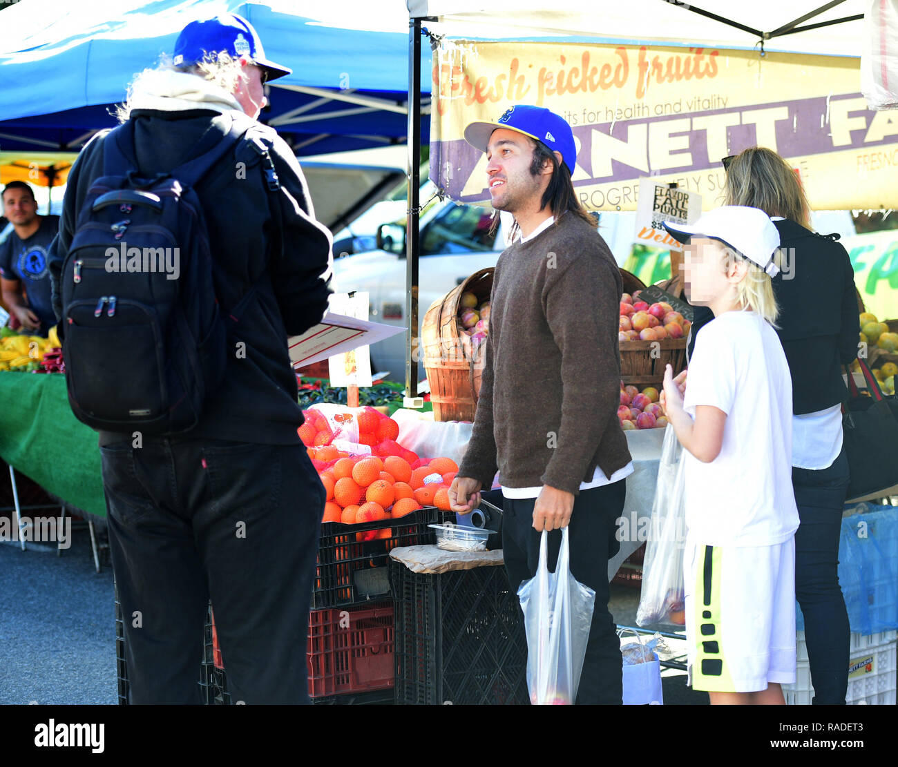 Pete Wentz signs an autograph for a fan while his son Bronx Wentz looks ...