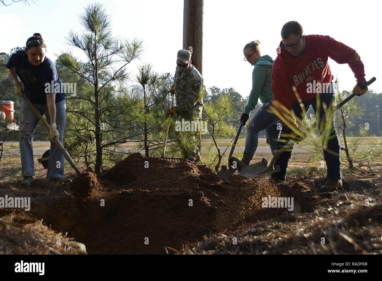 Team Shaw members shovel dirt into a defensive fighting position hole ...