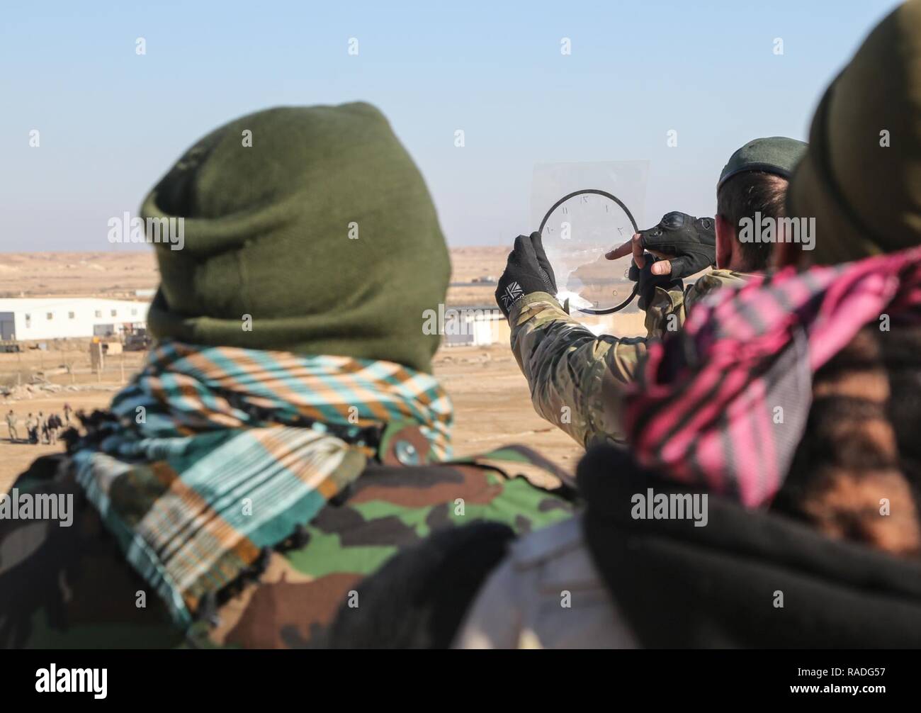 A British trainer from 4th Battalion "The Rifles" uses the clock ray ...