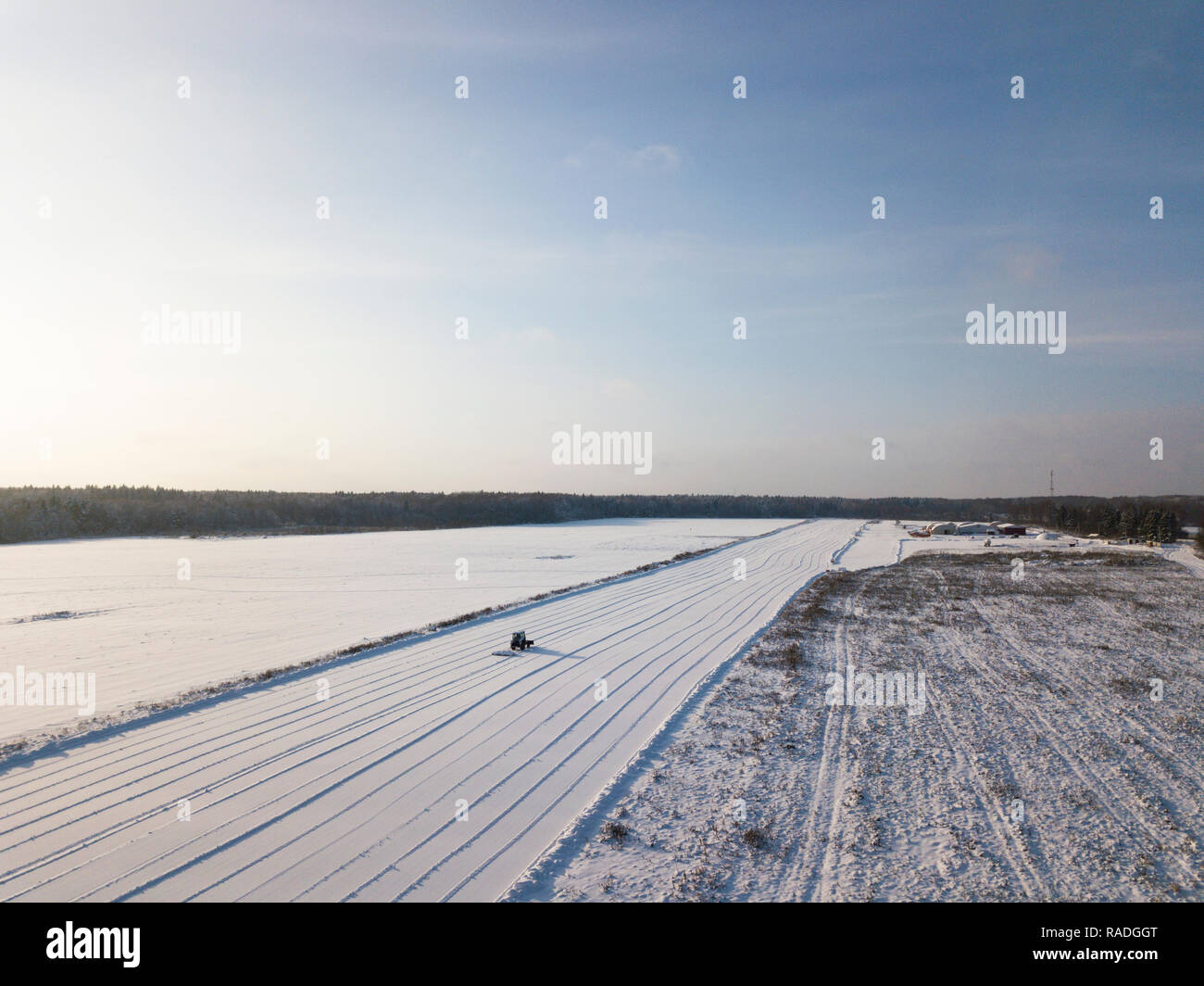 Aerial view of a tractor removing snow from a takeoff runway Stock ...