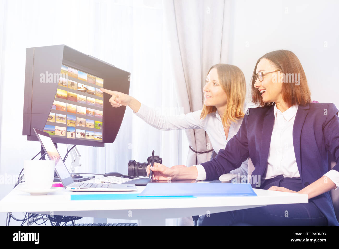 Photographer and client choosing portfolio images portraits Stock Photo ...