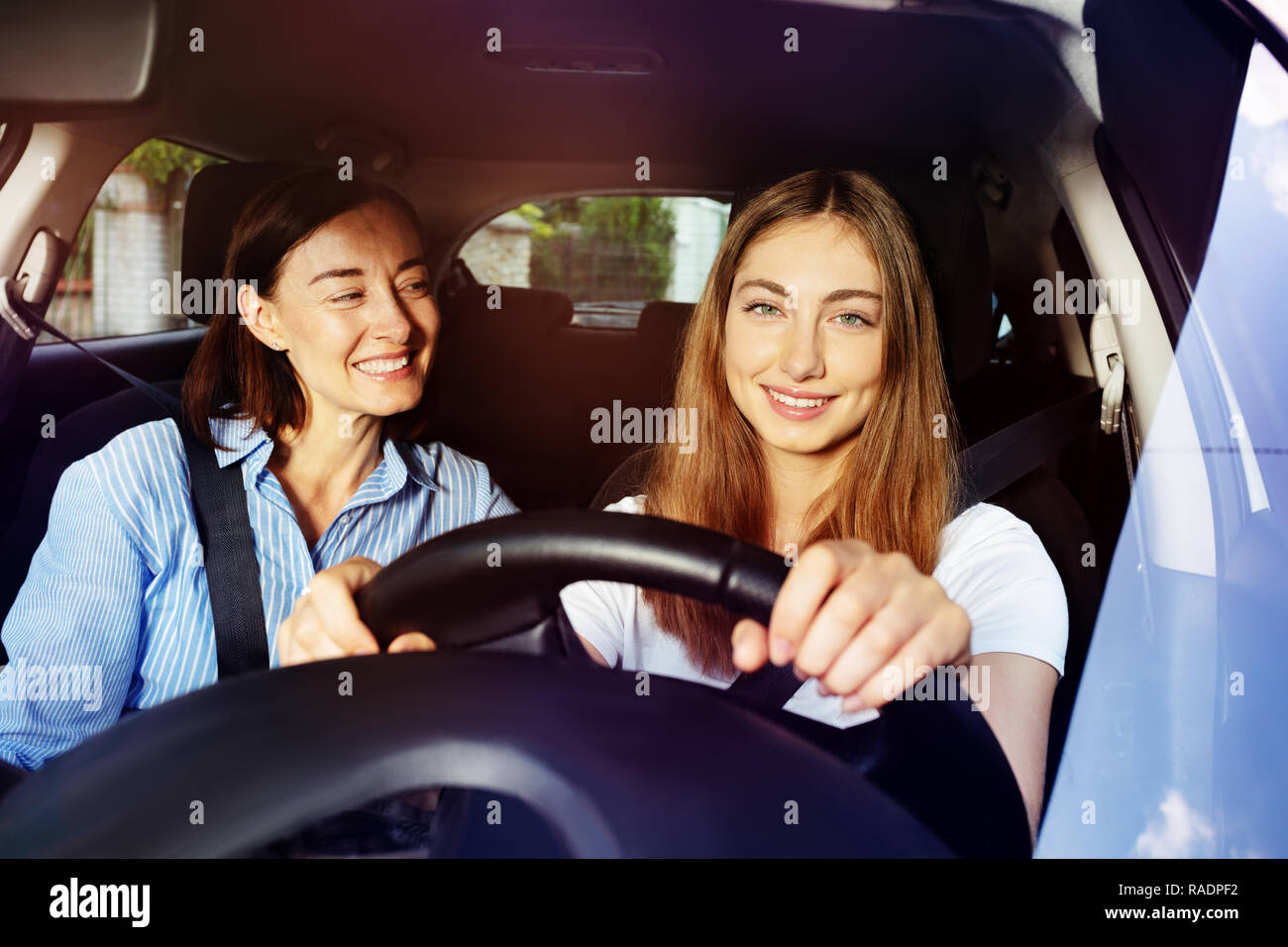 Happy adult daughter driving her mother in car Stock Photo - Alamy