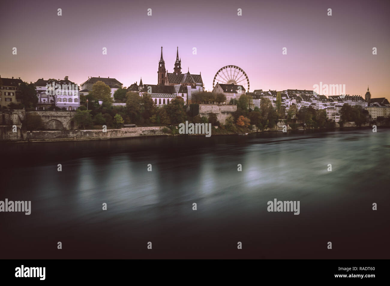 Purple sunset over the autumn fare ferry wheel in Basel, Switzerland ...