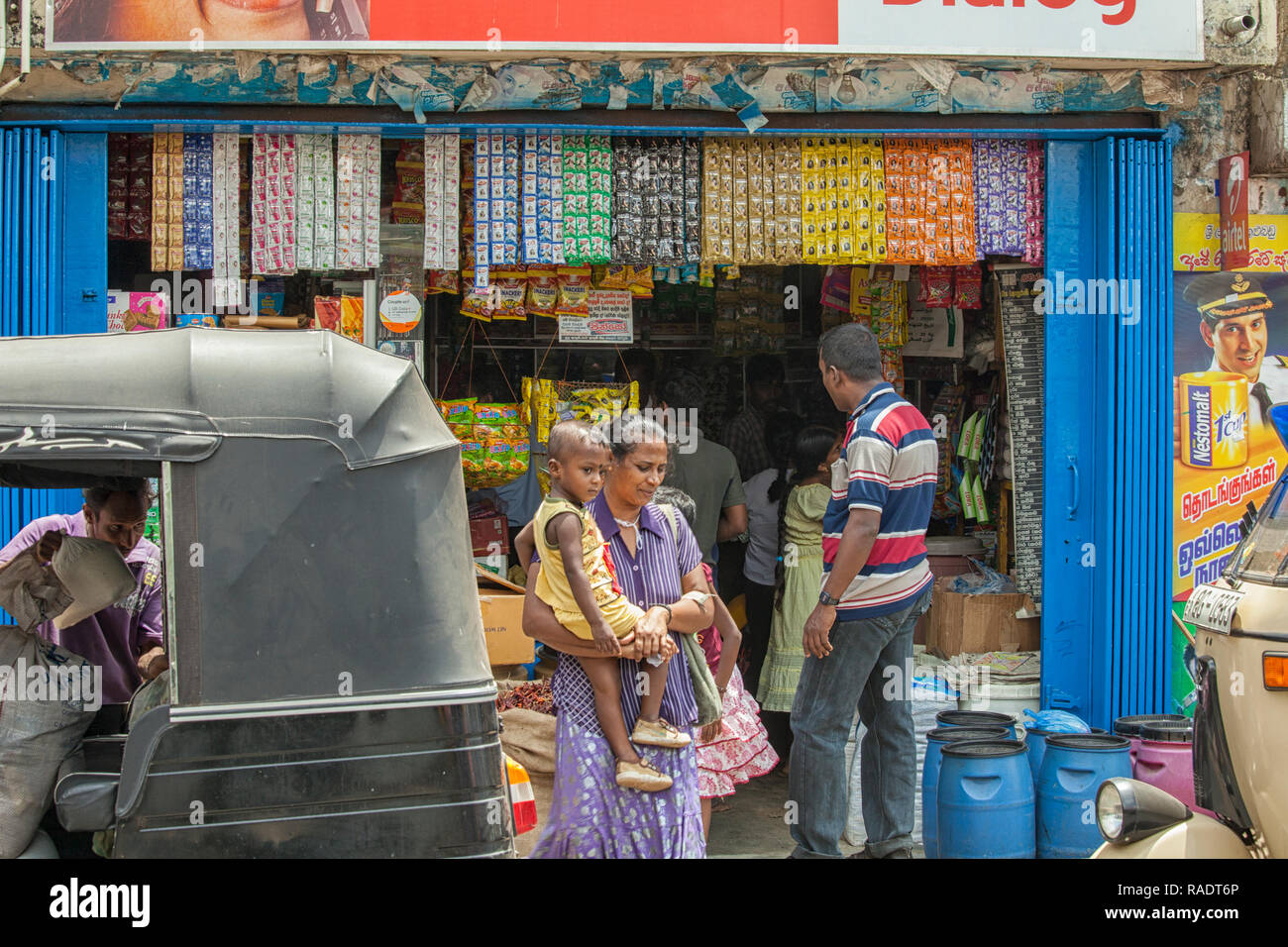 Mother and child in front of store on street of Trincomalee, Sri Lanka ...