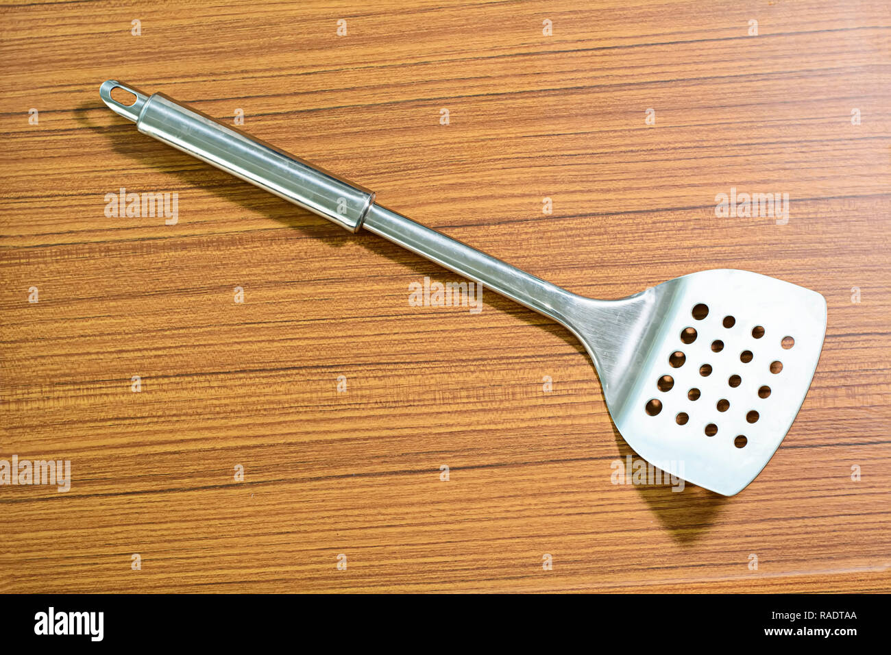 The kitchen turner on a wood background Stock Photo - Alamy