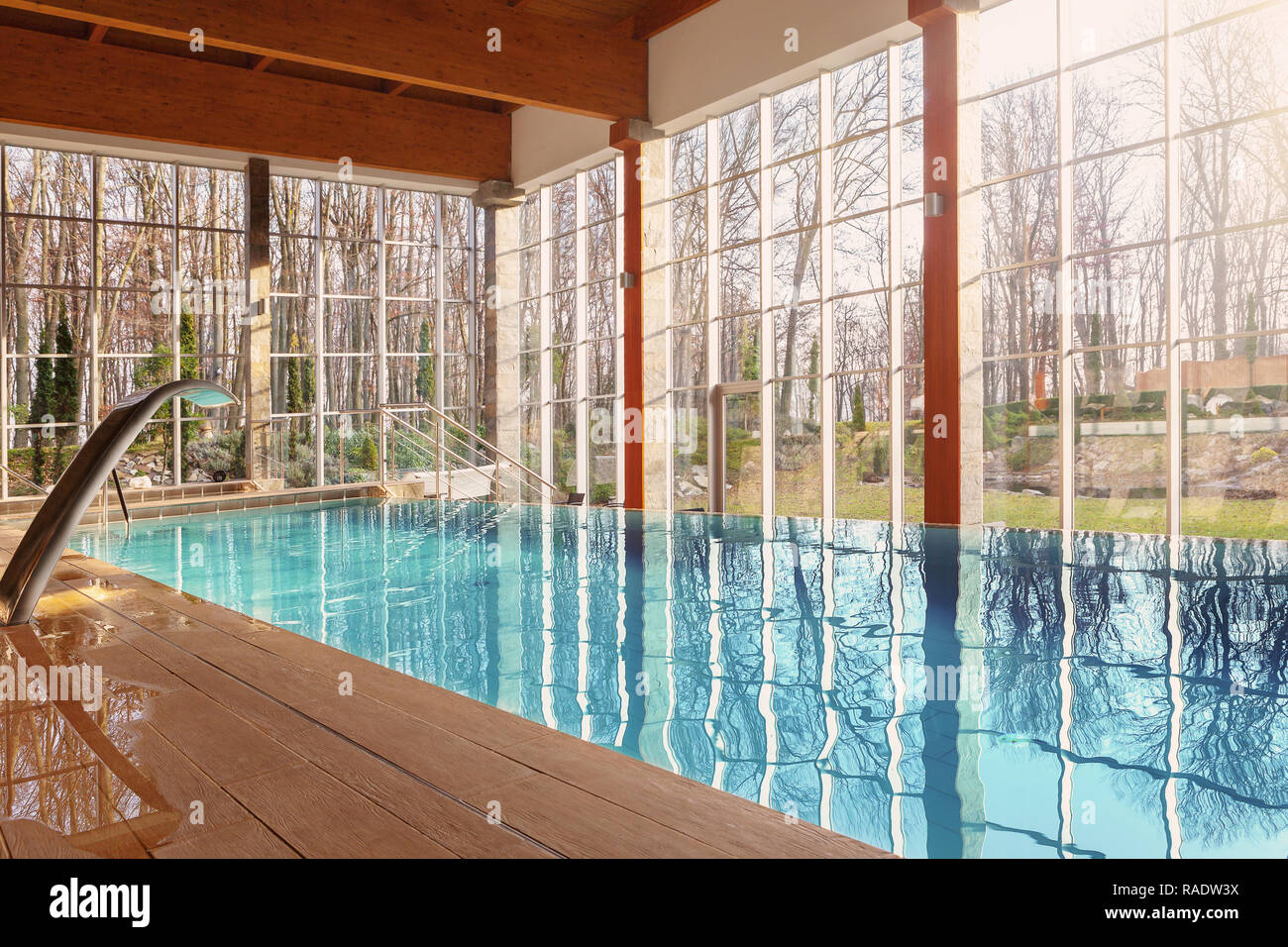 Luxurious empty infinity swimming pool with big glass windows with ...