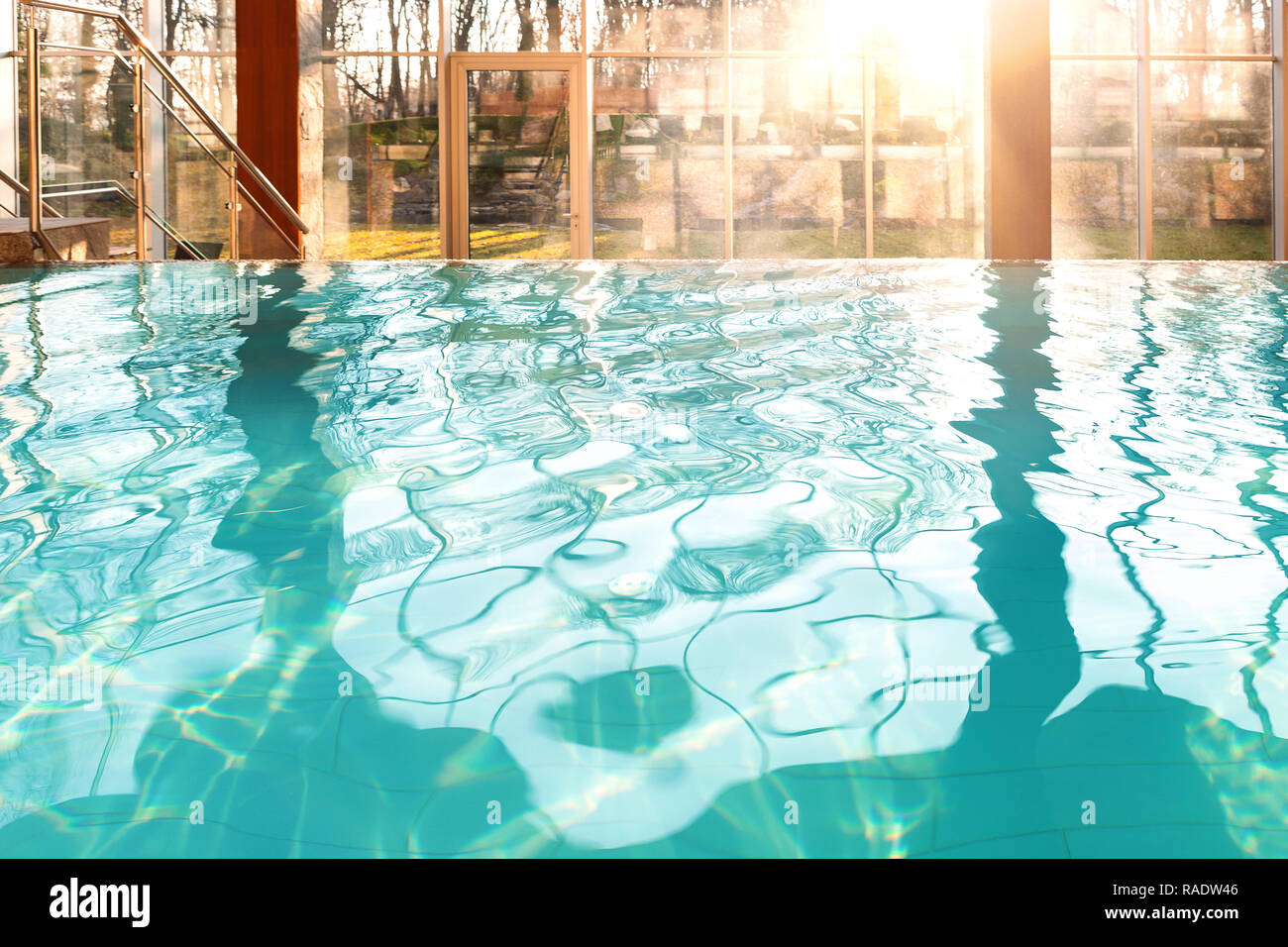 Luxurious empty infinity swimming pool with big glass windows with ...