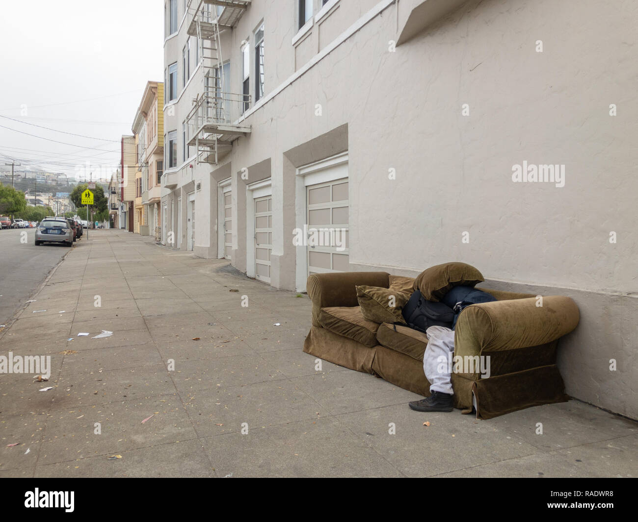 Homeless man sleeping on sofa Stock Photo - Alamy