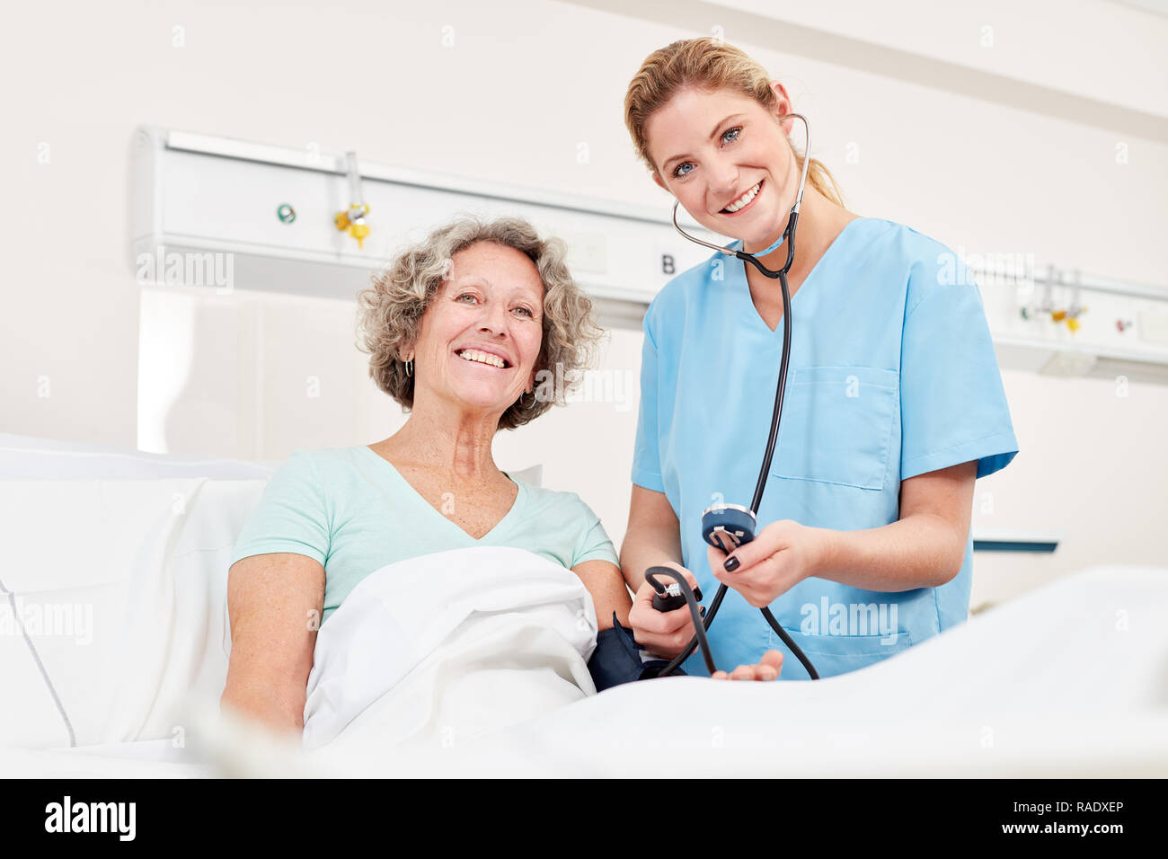 Patient and nurse measuring blood pressure in the hospital Stock Photo ...