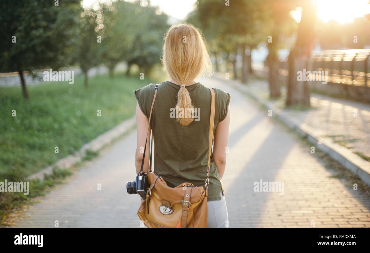Rear view of female photographer with retro camera Stock Photo - Alamy