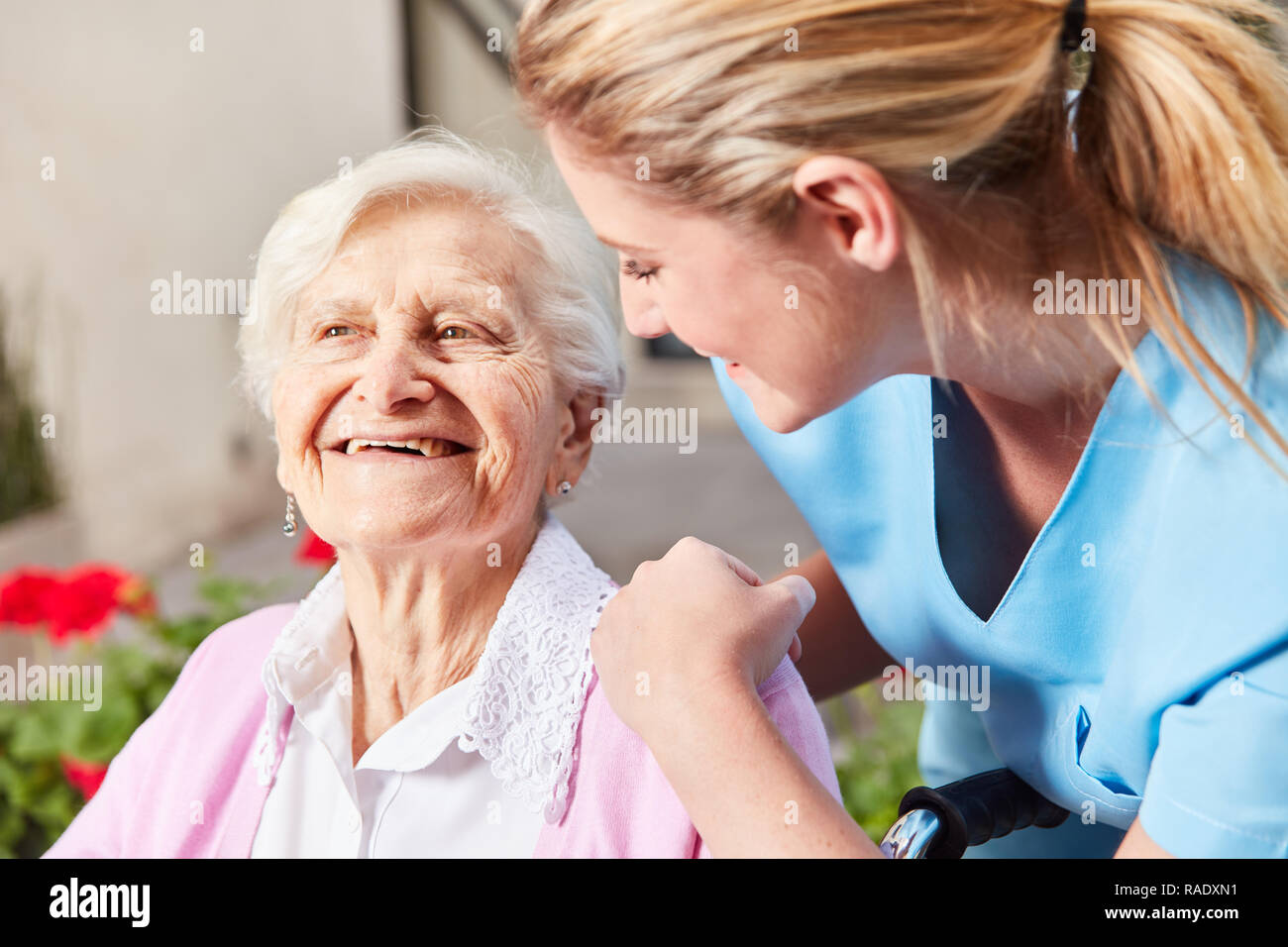 Caring Nurse Caring for Senior Woman in Wheelchair at Nursing Home ...