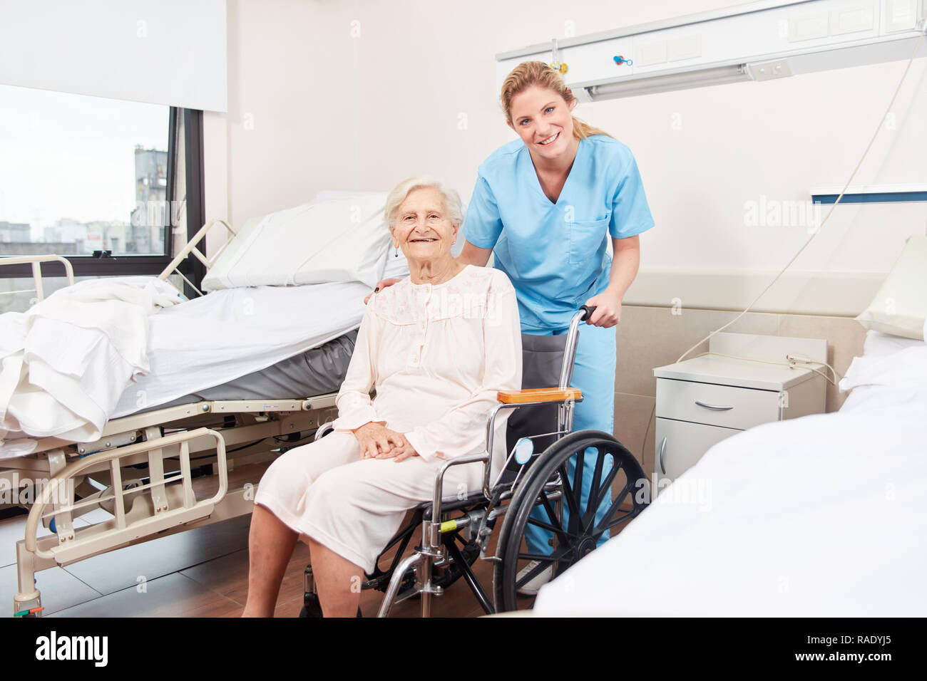Old woman in wheelchair together with nurse or geriatric nurse Stock ...