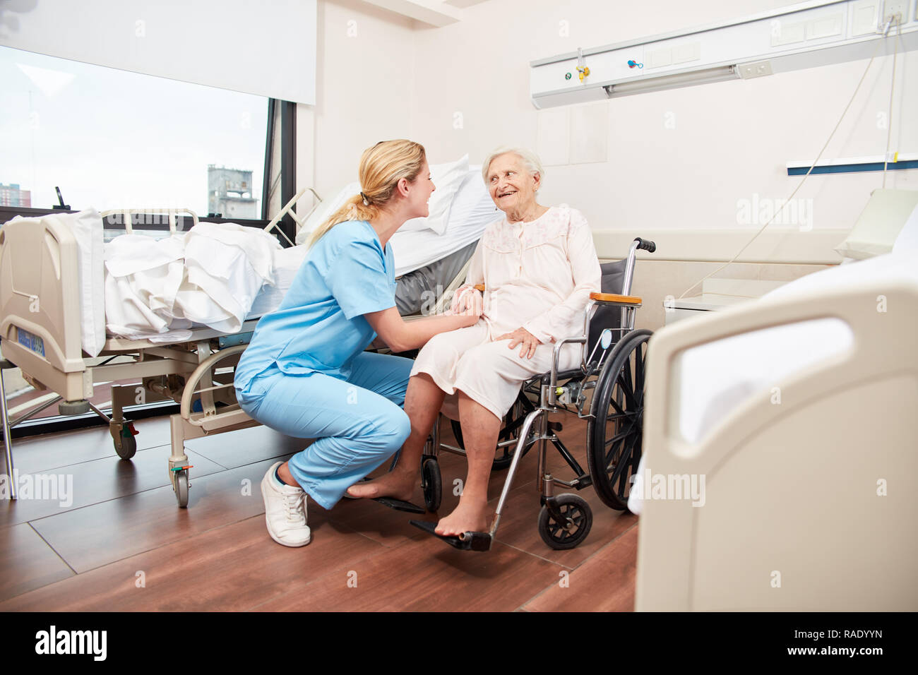 Nurse Caring Caring for Disabled Senior Woman in Wheelchair Stock Photo ...