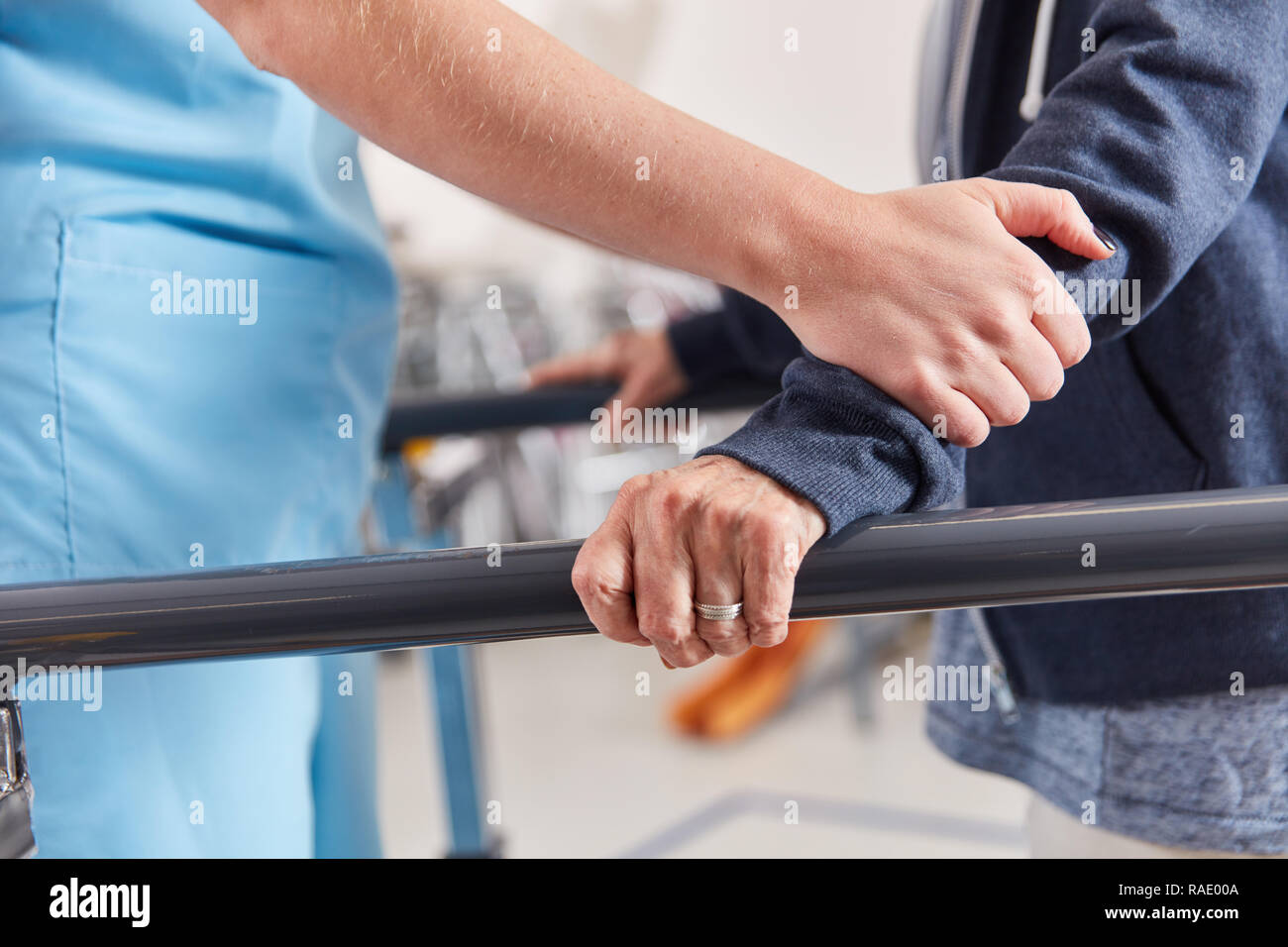 Hands of therapist support patient while running training in ...