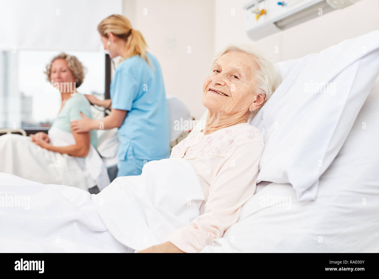 Happy senior citizen in hospital bed in nursing home or hospital Stock ...