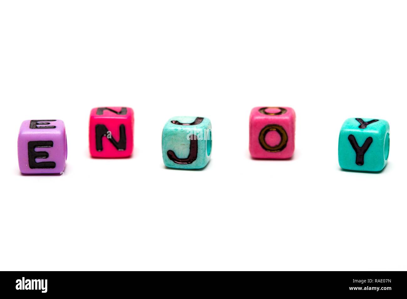 enjoy - word made from multicolored child toy cubes with letters Stock ...