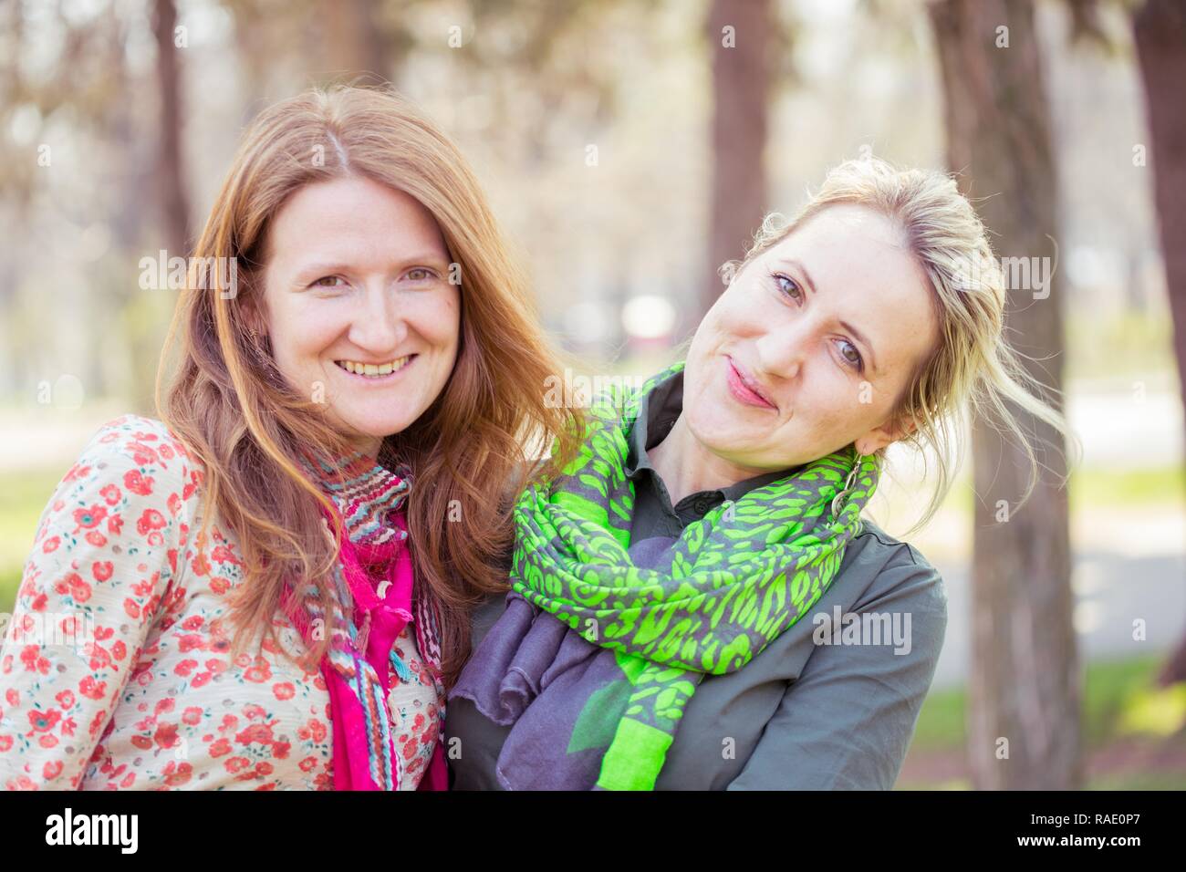 two smiling girlfriend portrait outdoors Stock Photo - Alamy