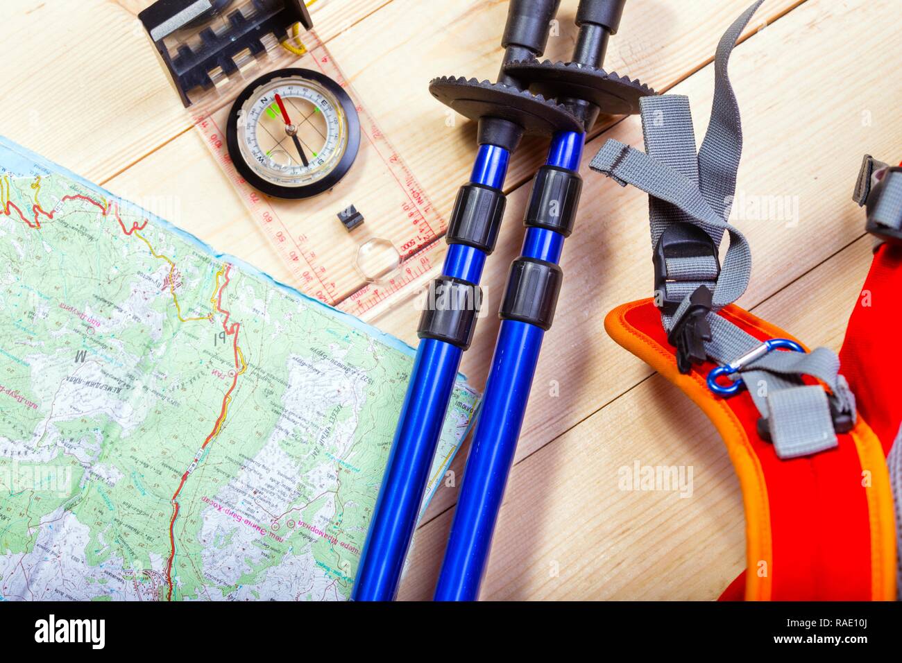 compass, map, trekking poles and backpack on a wooden background Stock ...