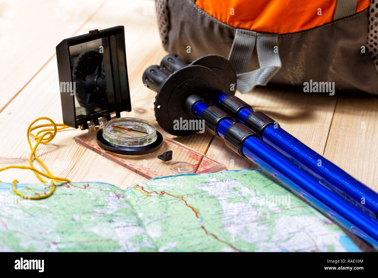 compass, map, trekking poles and backpack on a wooden background Stock ...