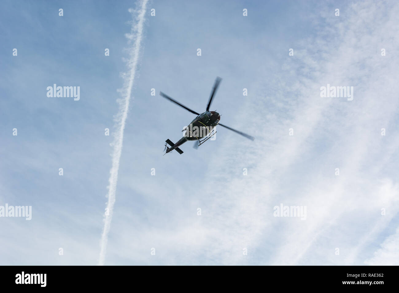 Underneath view of rescue helicopter flying above Stock Photo - Alamy