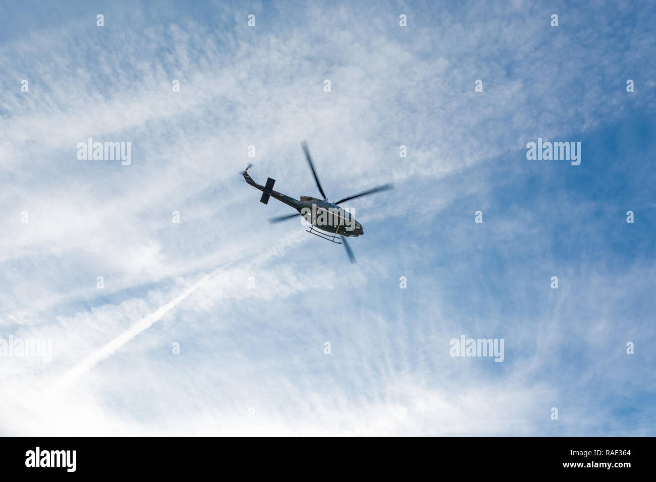 Underneath view of rescue helicopter flying above Stock Photo - Alamy
