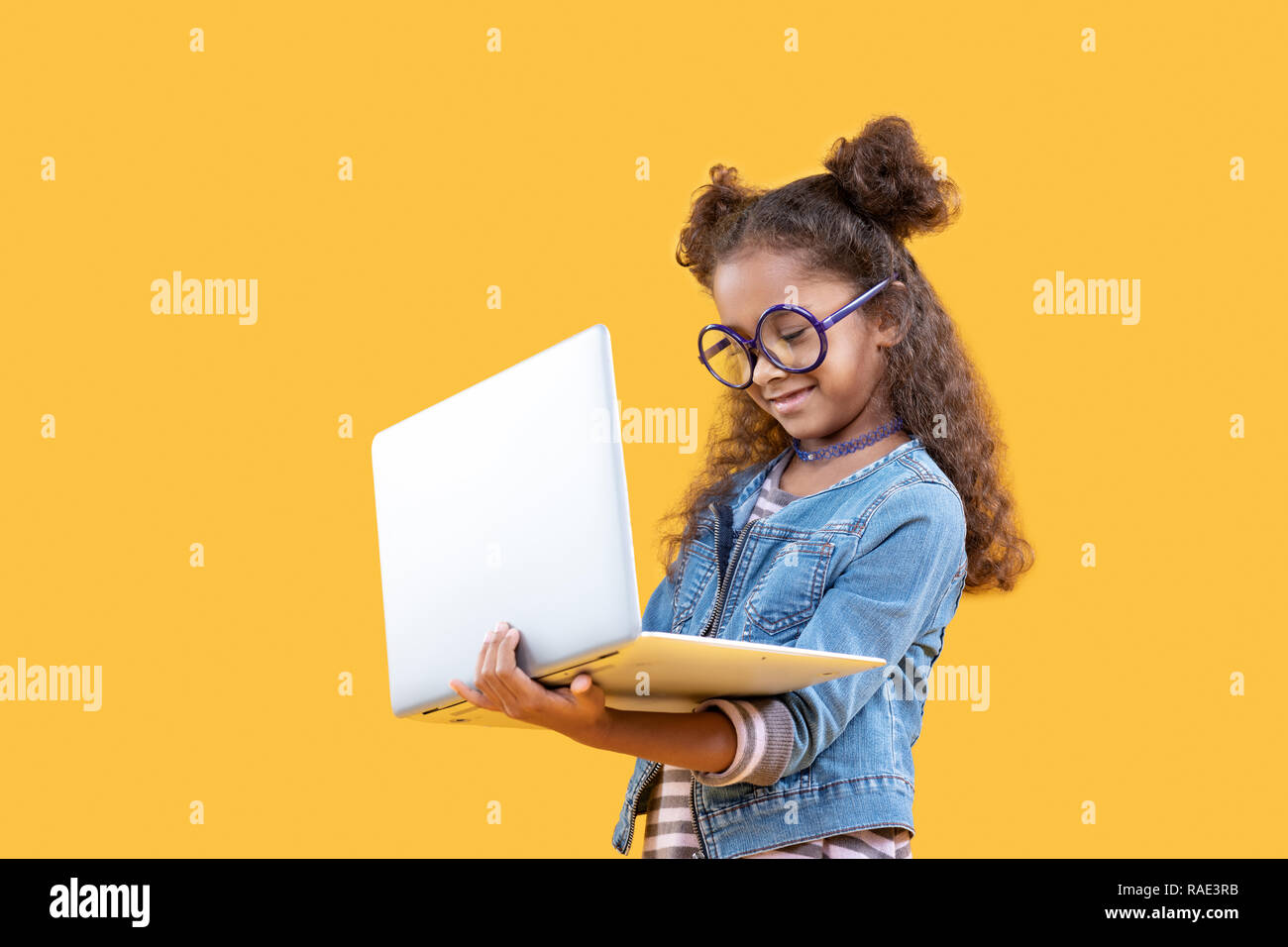 Cute happy girl looking at the computer screen Stock Photo - Alamy