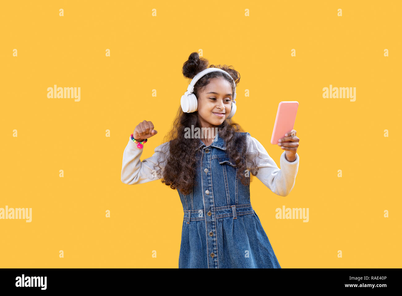 Nice cheerful girl dancing to a song Stock Photo - Alamy