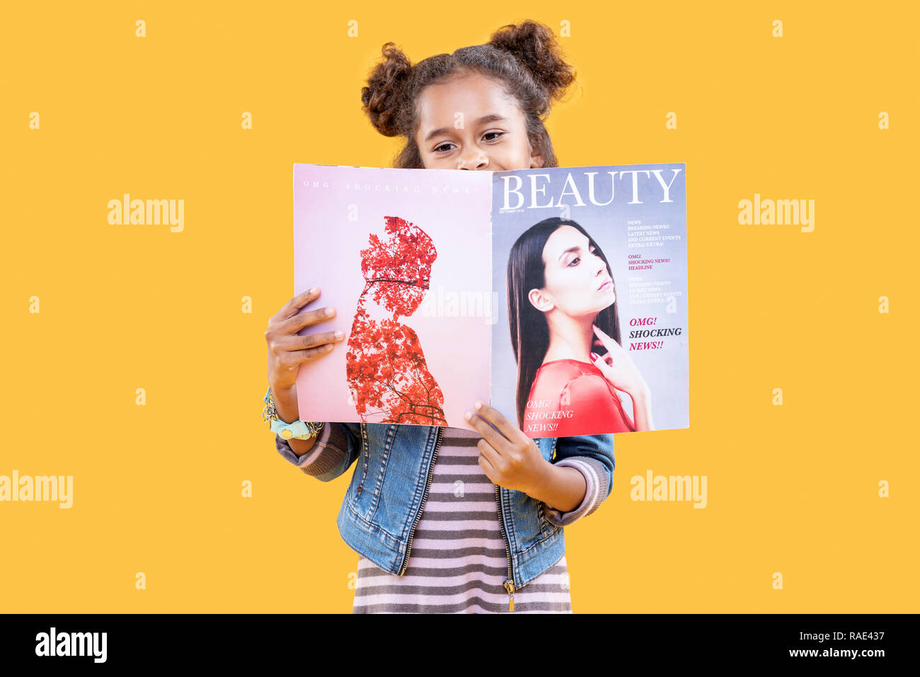 Delighted happy girl enjoying reading a magazine Stock Photo - Alamy