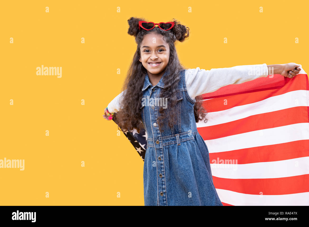 Cheerful pretty girl holding an American national symbol Stock Photo ... Cheerful pretty girl holding an American national symbol Stock Photo ...