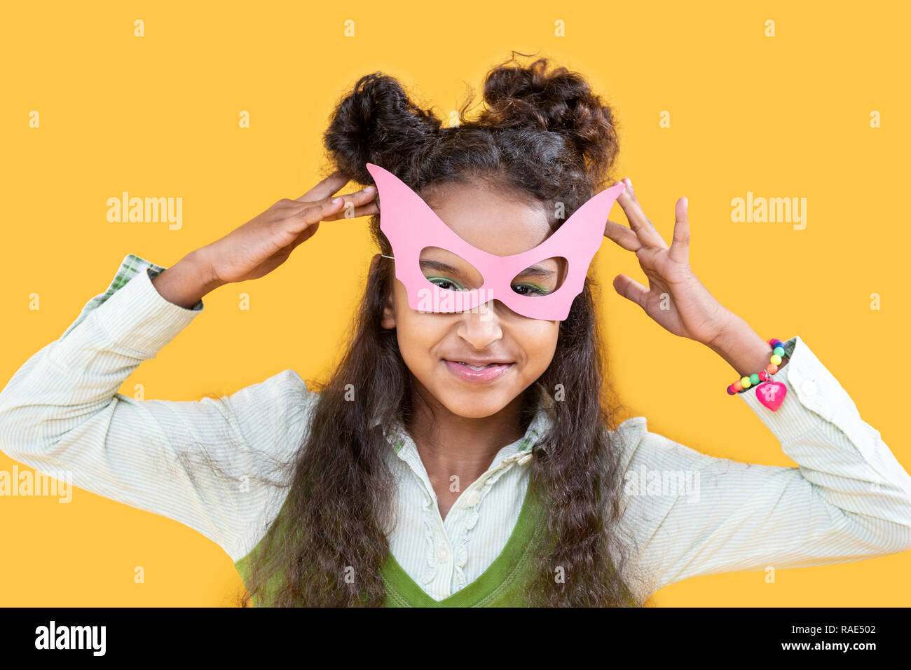 Cheerful nice girl wearing a masquerade mask Stock Photo - Alamy