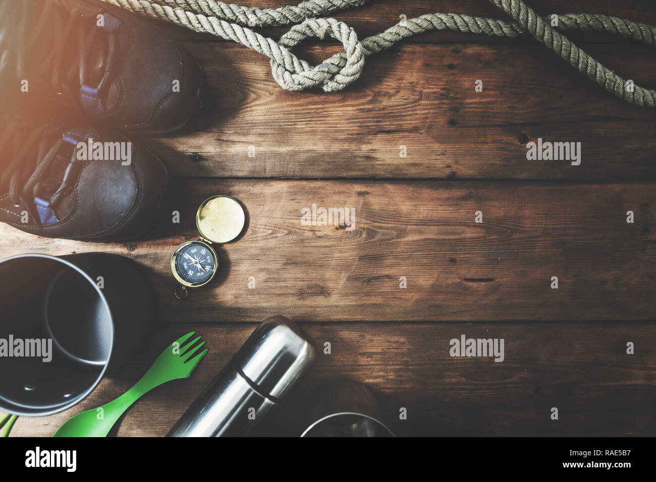 outdoor adventures - expedition camping items on wooden background with ...