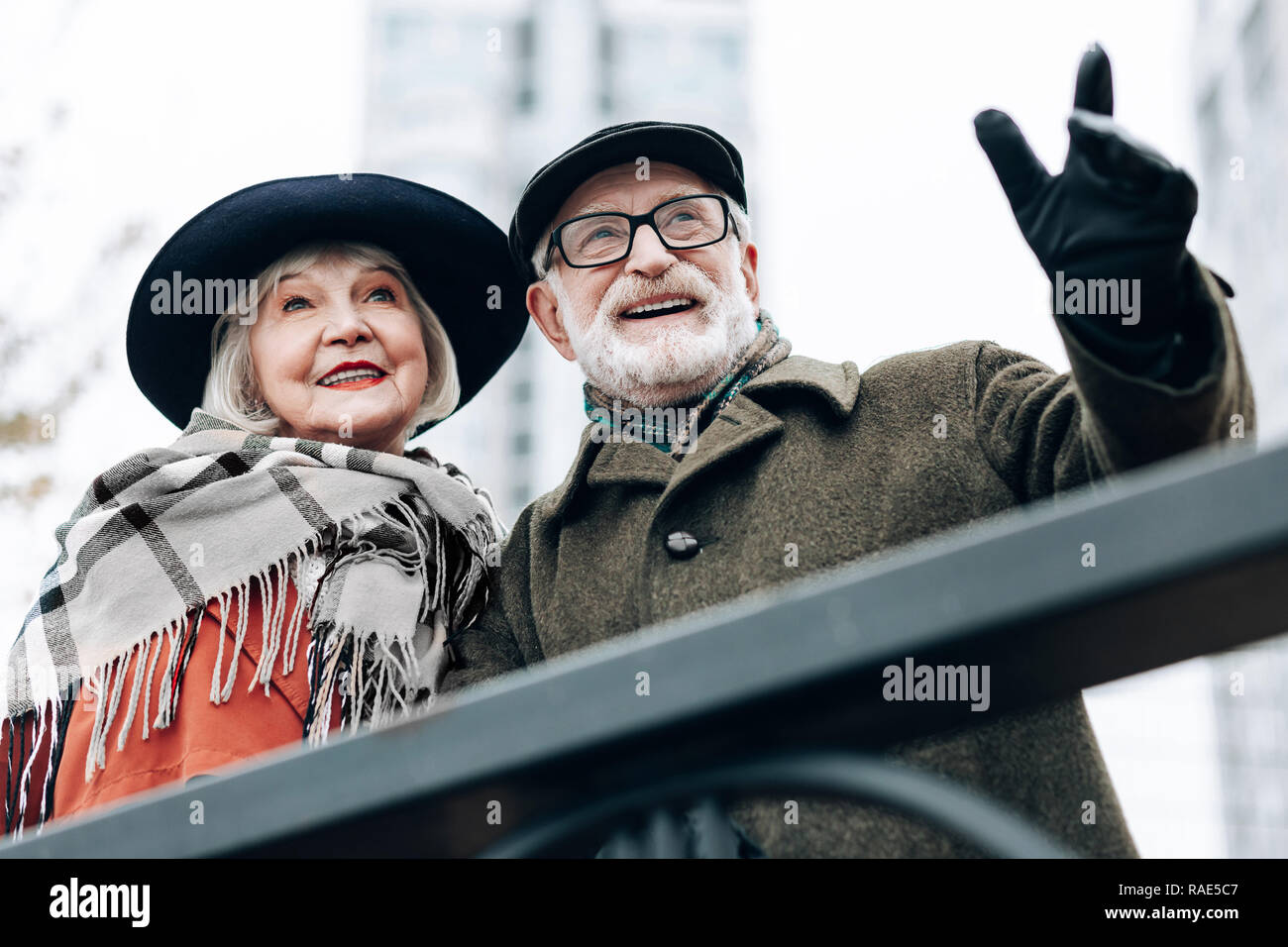Positive delighted couple looking in one direction Stock Photo - Alamy