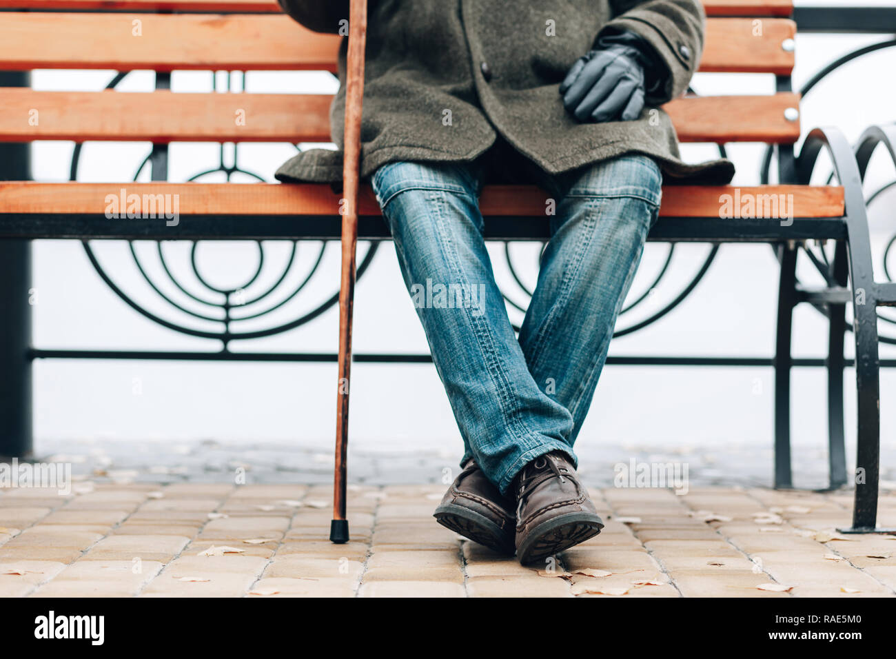 Focused photo on male legs that being crosses Stock Photo - Alamy