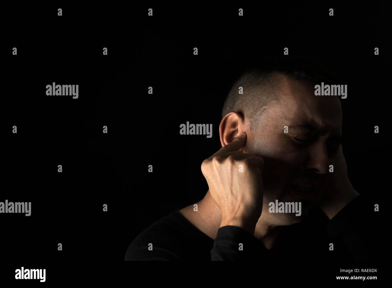 closeup of a suffering caucasian man with one hand in his head and the ...