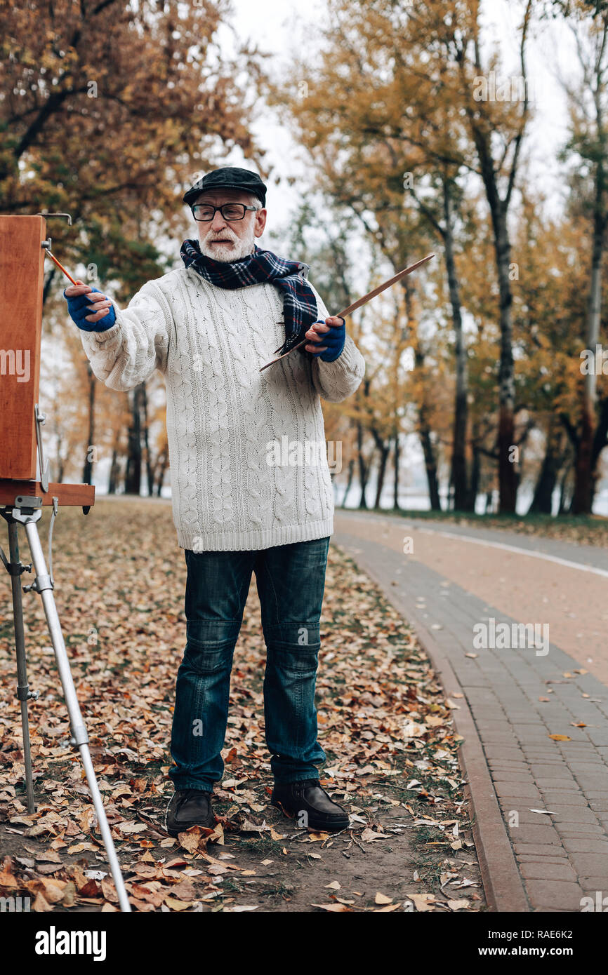 Concentrated male person looking at his draw Stock Photo - Alamy