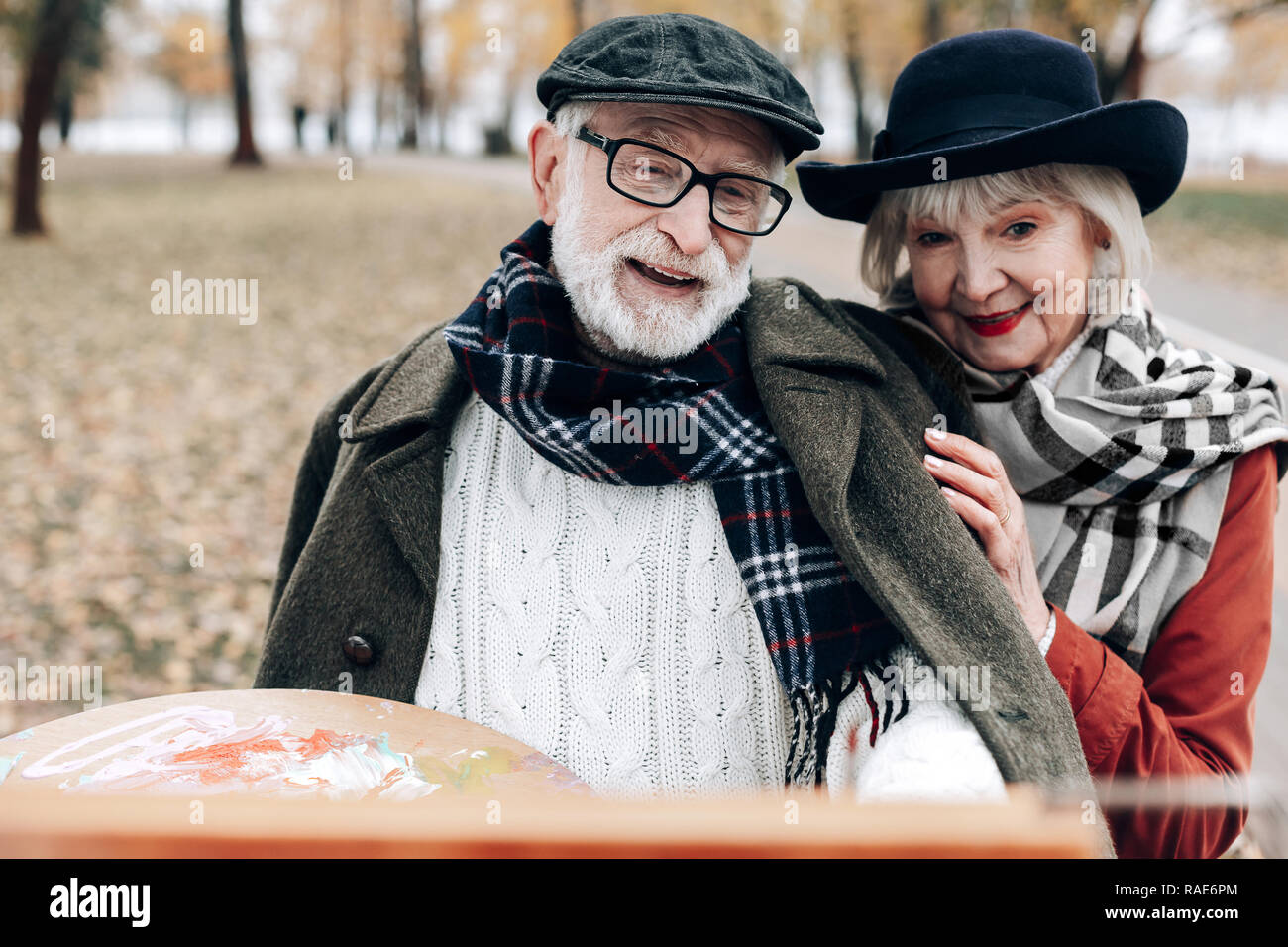 Positive delighted couple looking at finished picture Stock Photo - Alamy