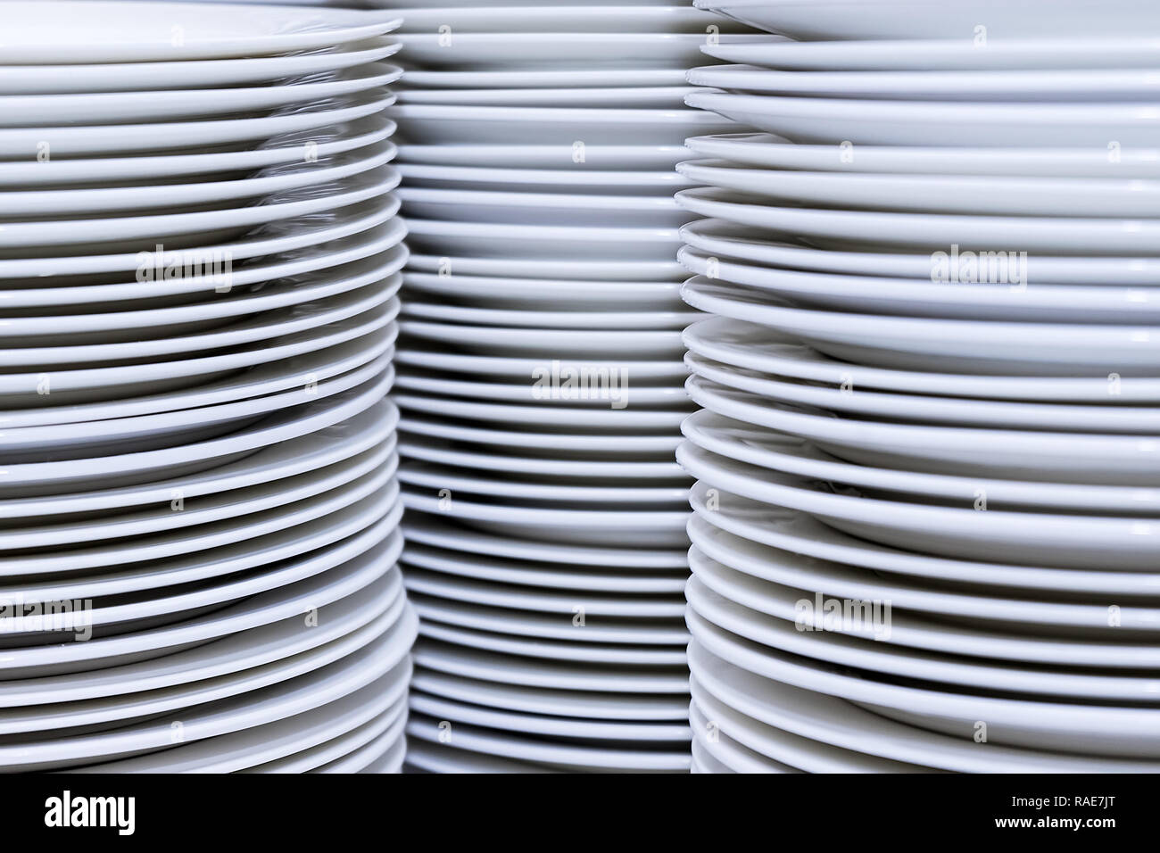 large stacks of clean white plates after washing in the kitchen Stock ...