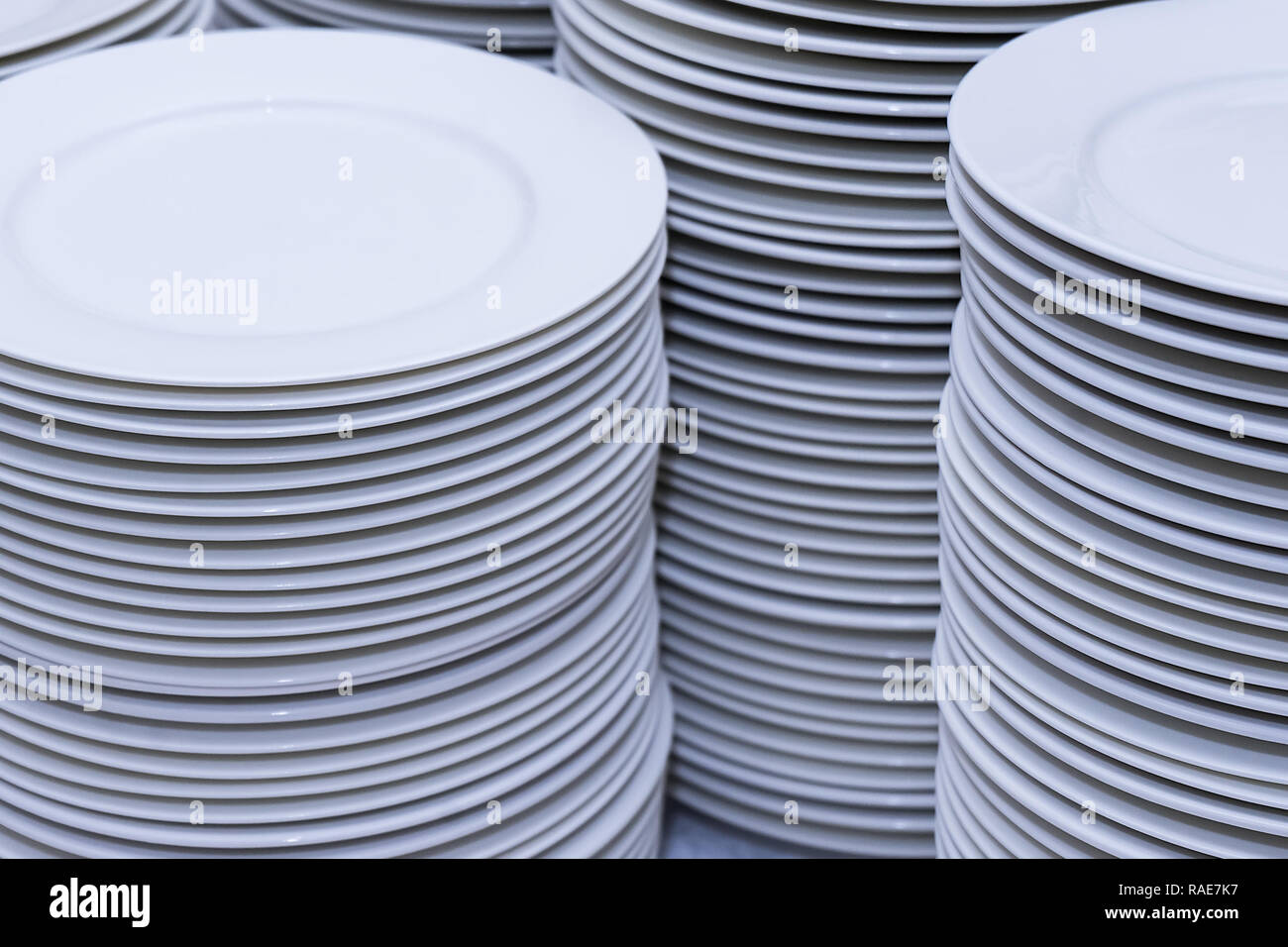 large stacks of clean white plates after washing in the kitchen Stock ...