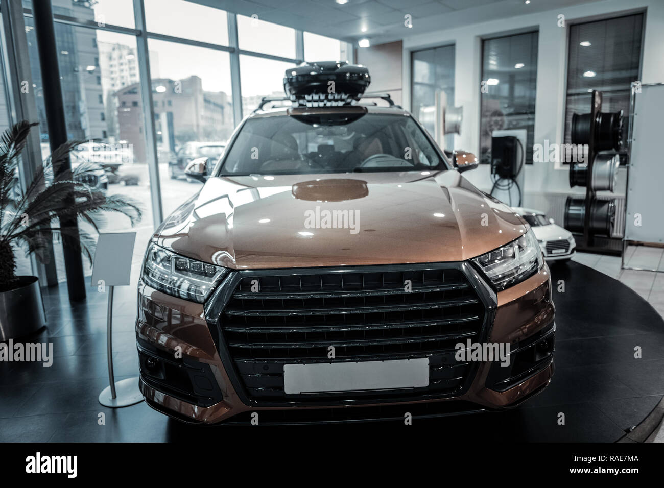 New hatchback car of nice brown color standing in car salon Stock Photo ...