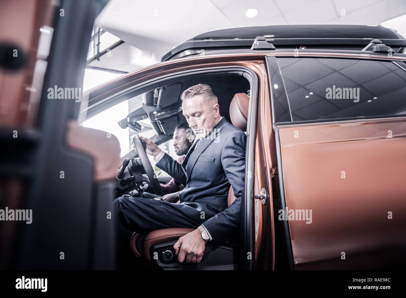 Sitting business man pushing back to hi-res stock photography and ...