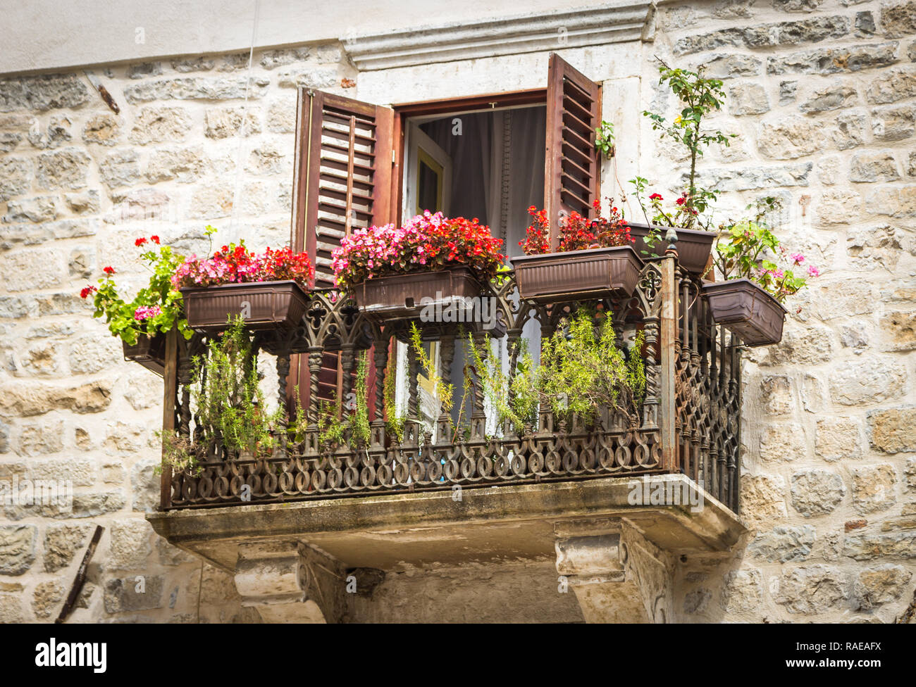 Beautiful vintage balcony with openwork metal railings, decorated with ...