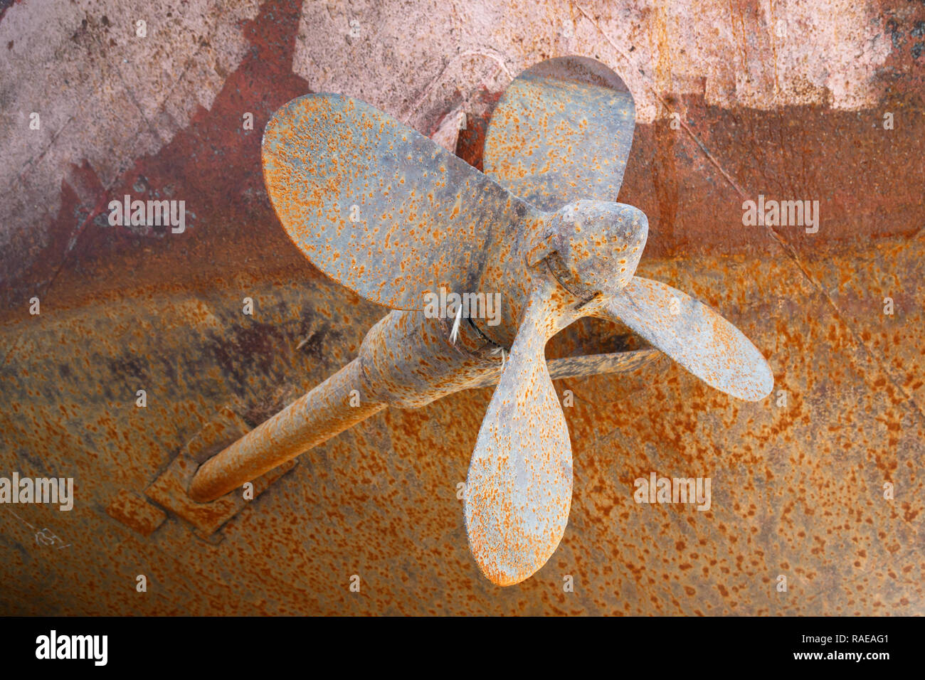 Rusted shaft of a ship and a screw come out of the hull of the ship in ...