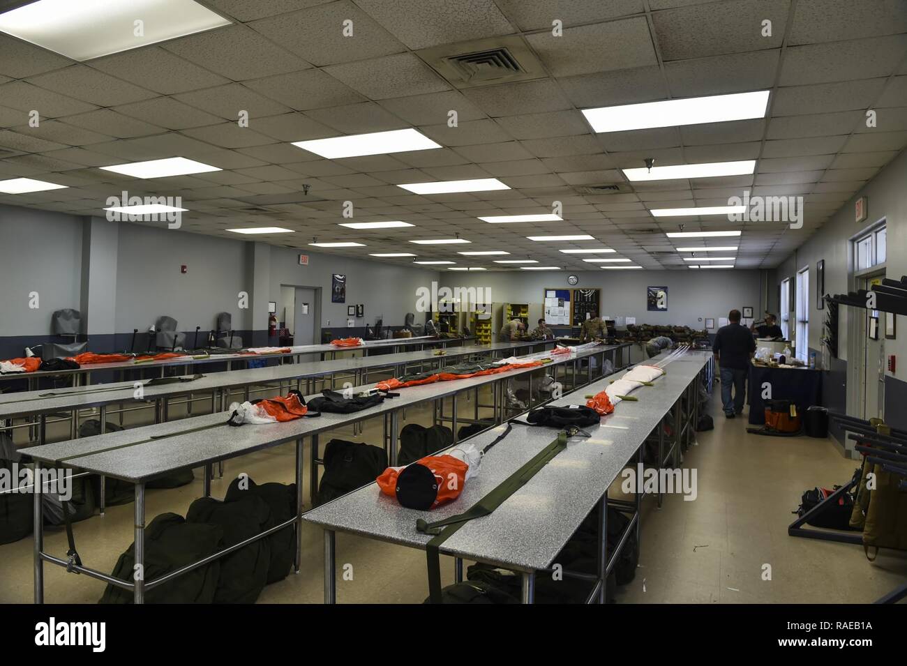 Parachutes line the tables as aircrew flight equipment specialists with ...