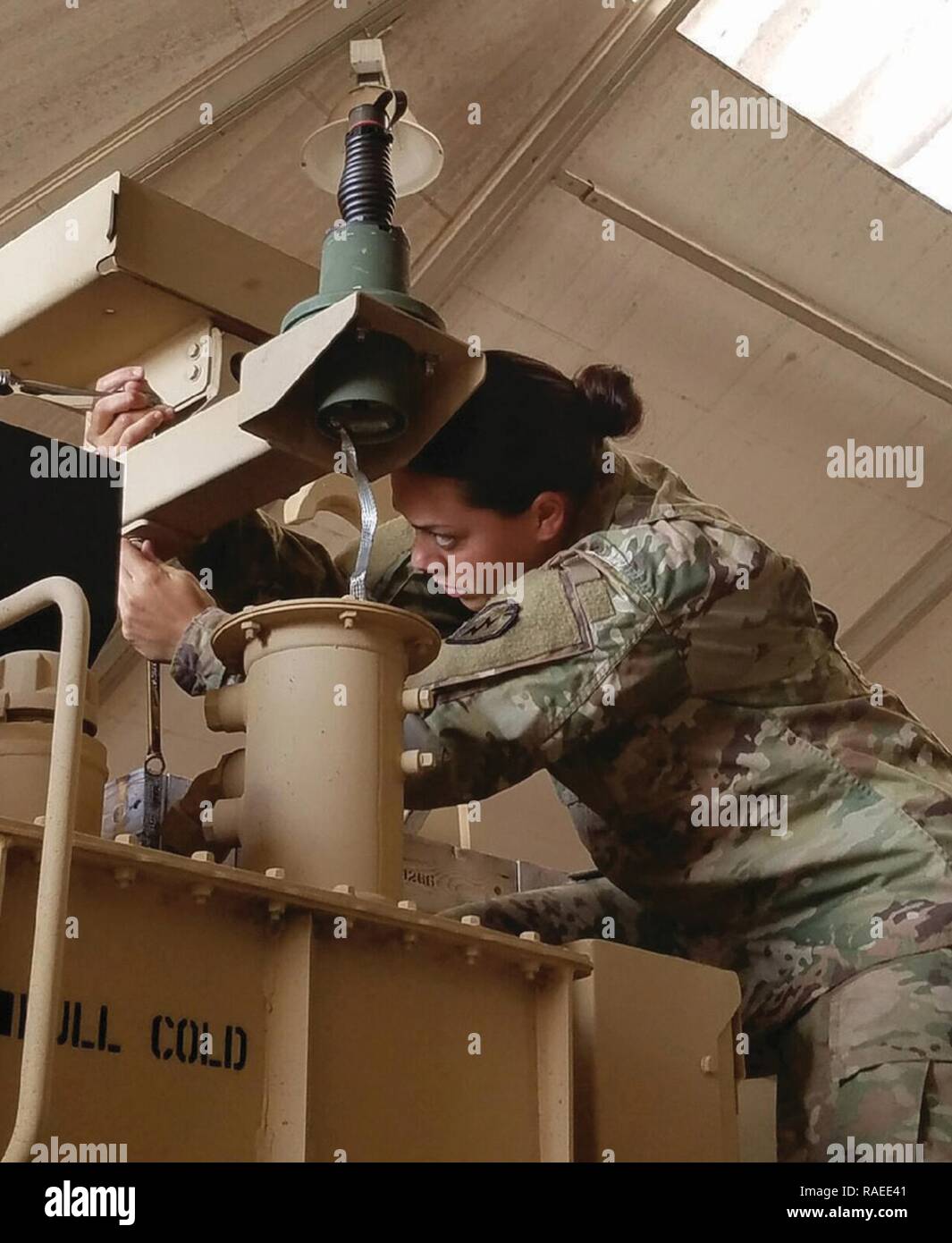 A Soldier from the 25th Infantry Brigade Combat Team installs an AS ...
