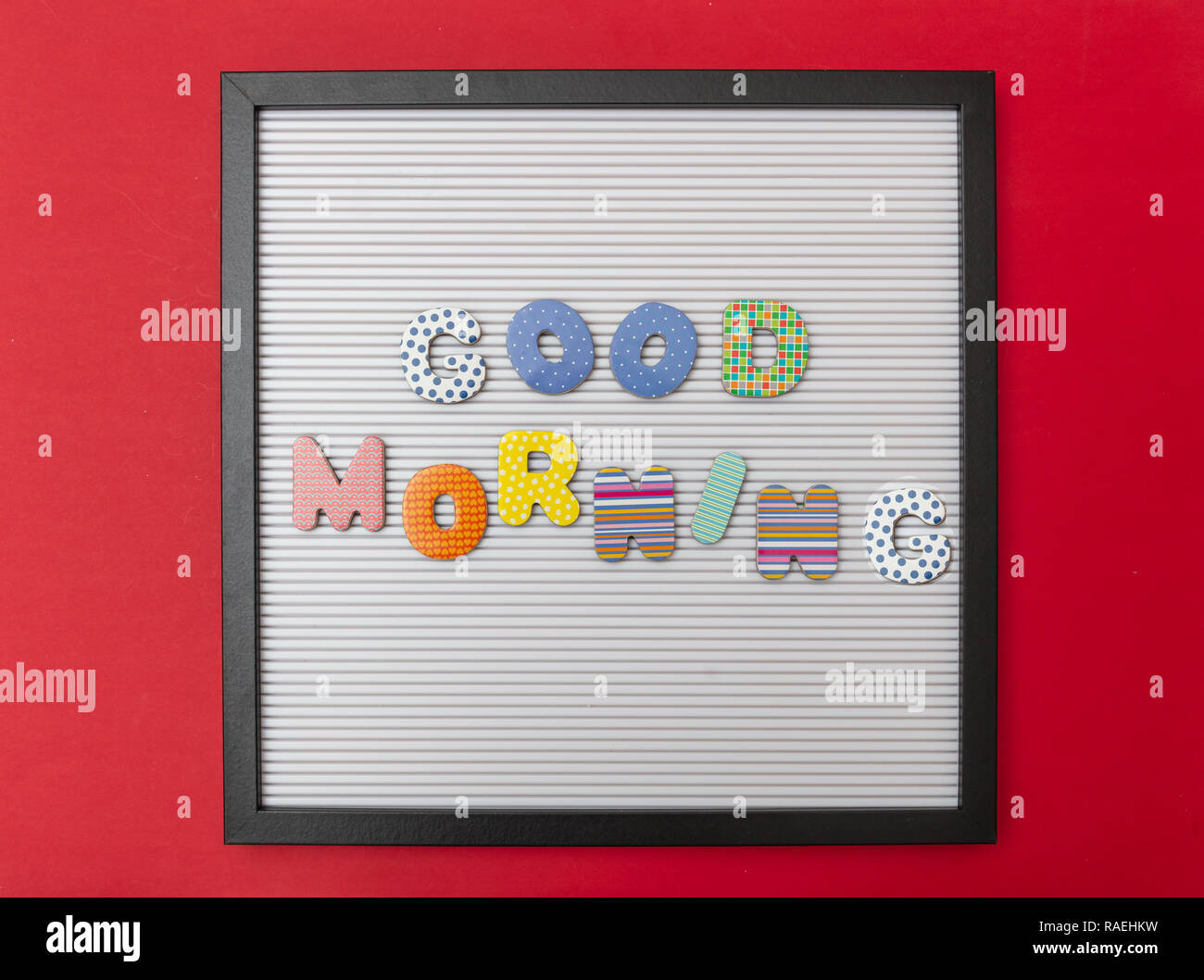 Good morning. Board with black frame, text Good morning in colorful ...