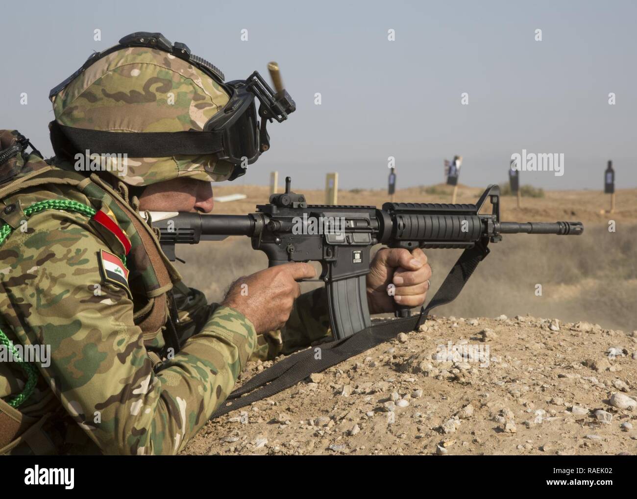 An Iraqi soldier fires his M4 rifle during a live fire exercise at the ...